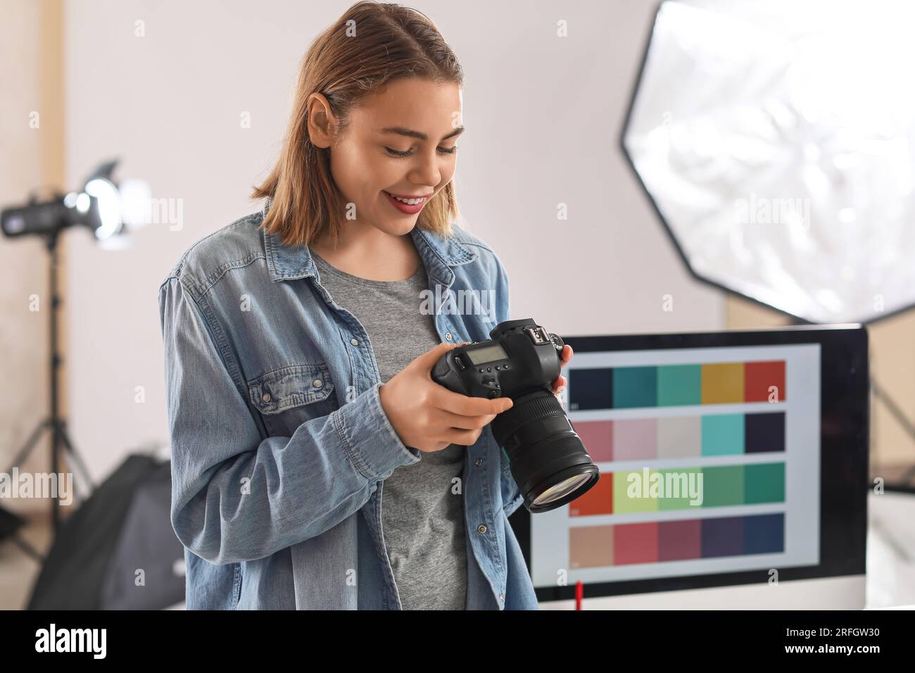Female photographer with professional camera in studio Stock Photo - Alamy