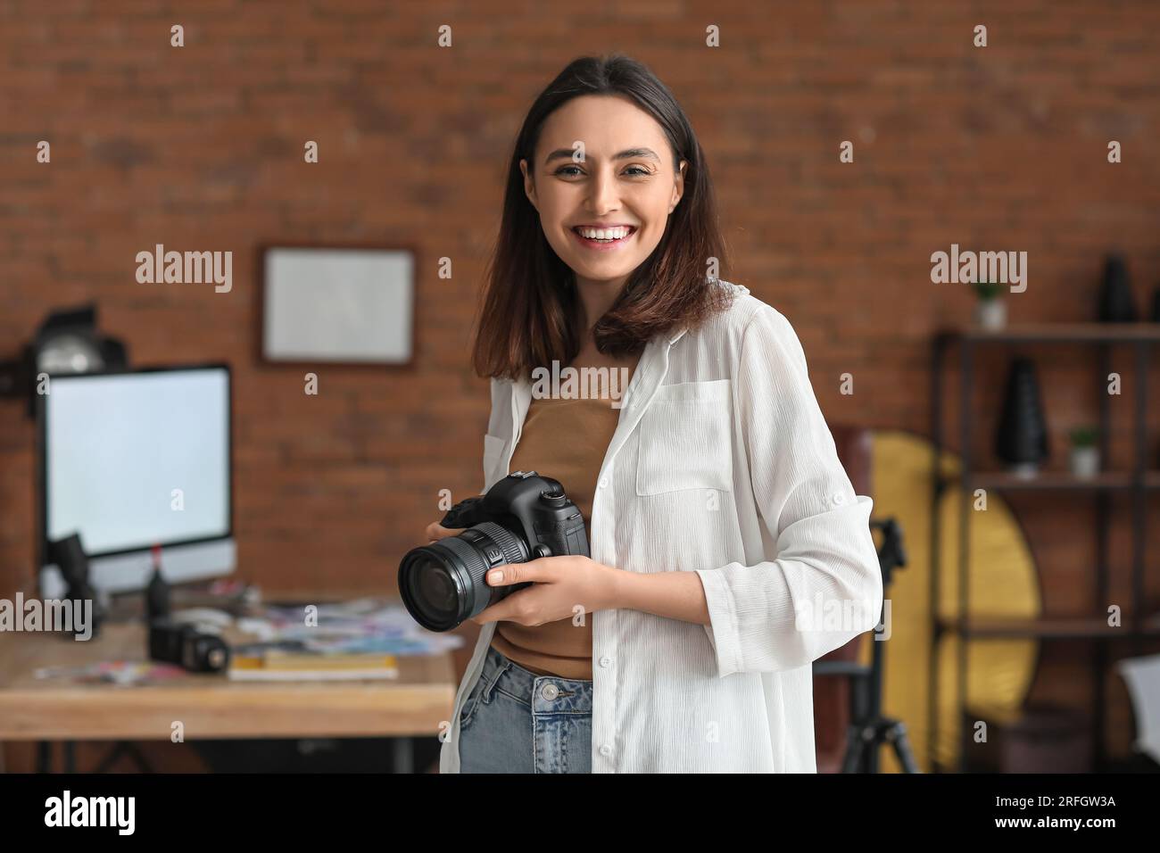 Female photographer with professional camera in studio Stock Photo - Alamy