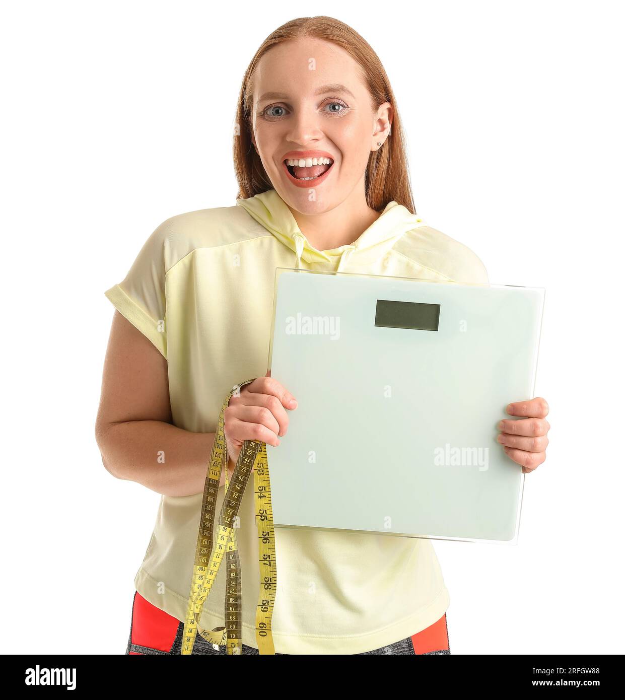 Young overweight woman with scales and tape measure on white background ...