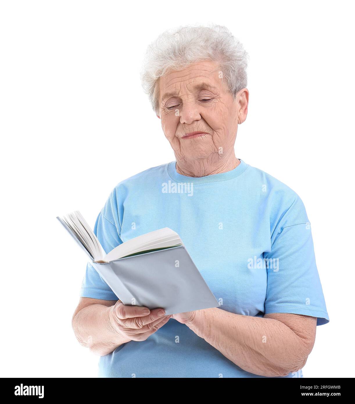 Senior woman reading book on white background Stock Photo - Alamy