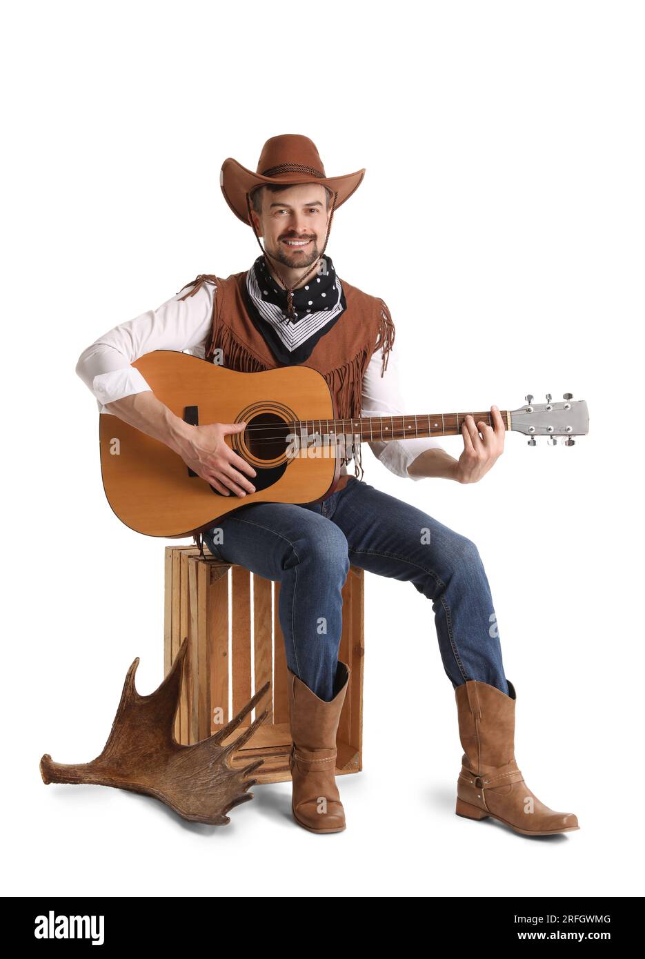 Handsome cowboy playing guitar on white background Stock Photo - Alamy