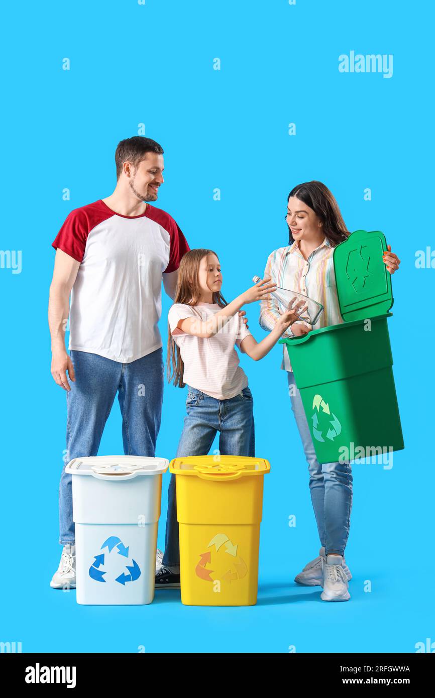Family sorting garbage in recycle bins on blue background Stock Photo ...