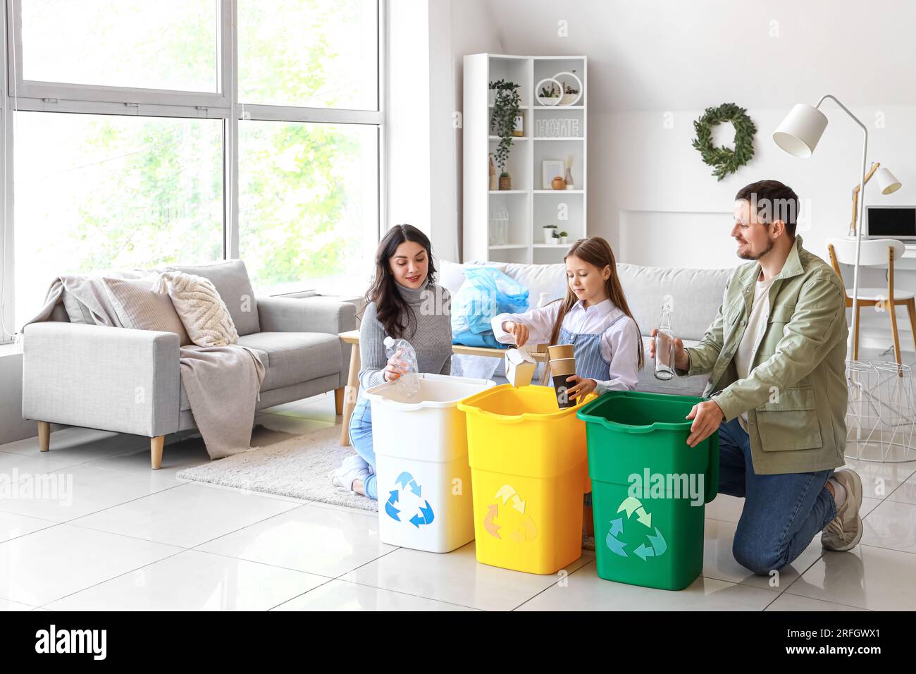 Family sorting garbage in recycle bins at home Stock Photo - Alamy