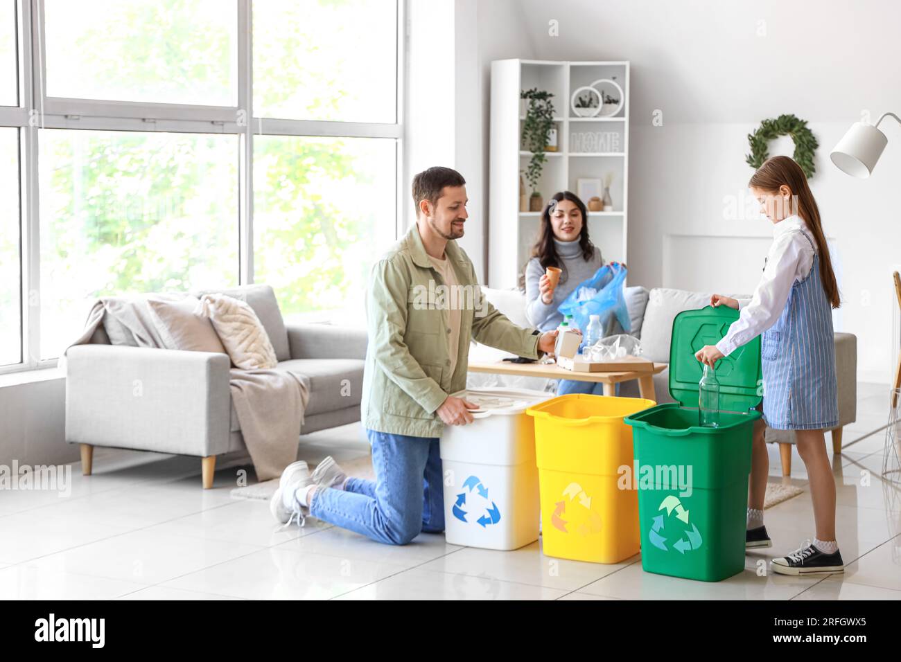 Family sorting garbage in recycle bins at home Stock Photo - Alamy