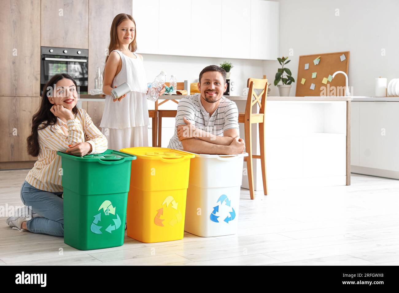 Family with recycle trash bins in kitchen Stock Photo - Alamy
