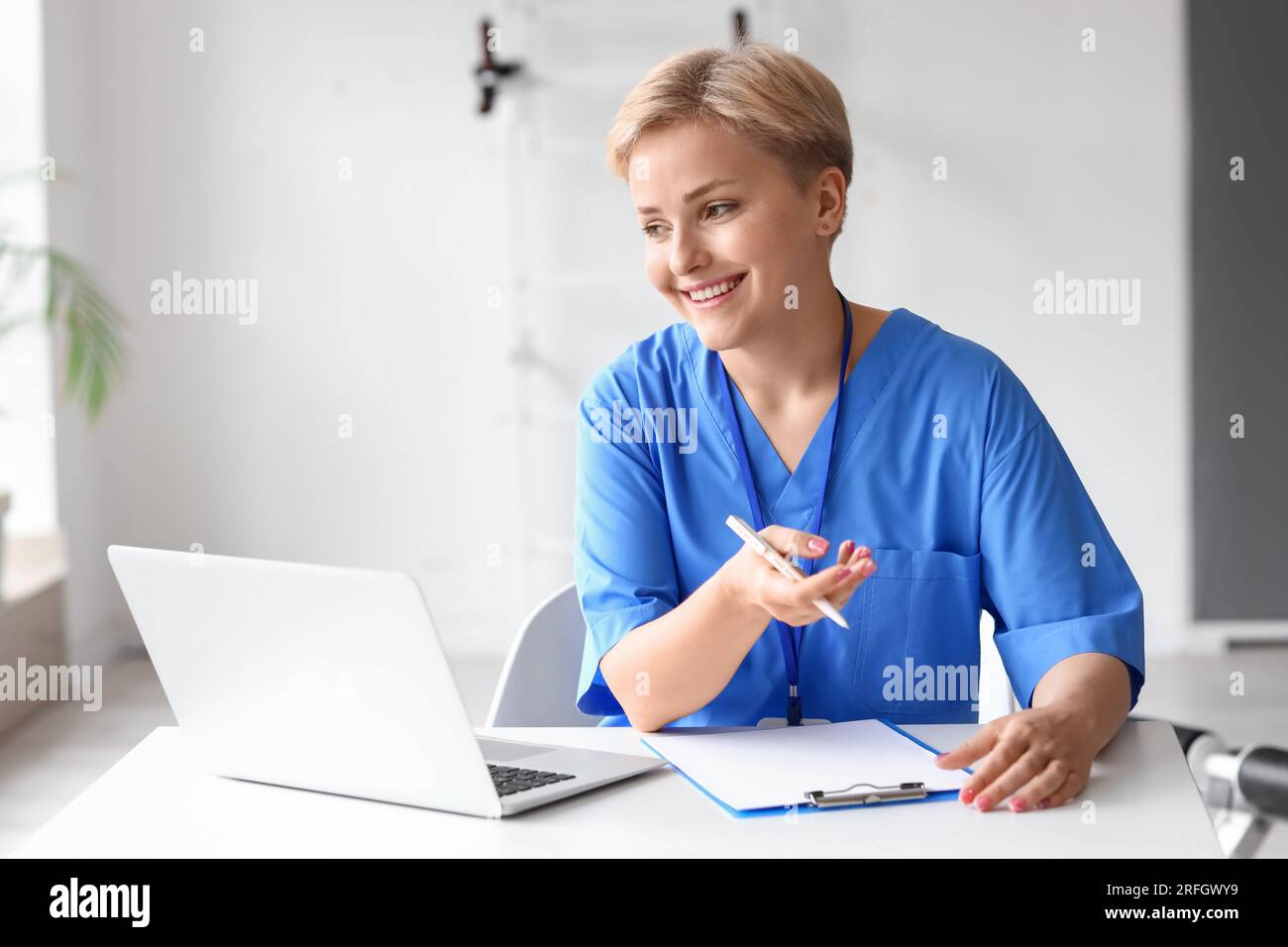 Female medical intern working at reception in clinic Stock Photo - Alamy