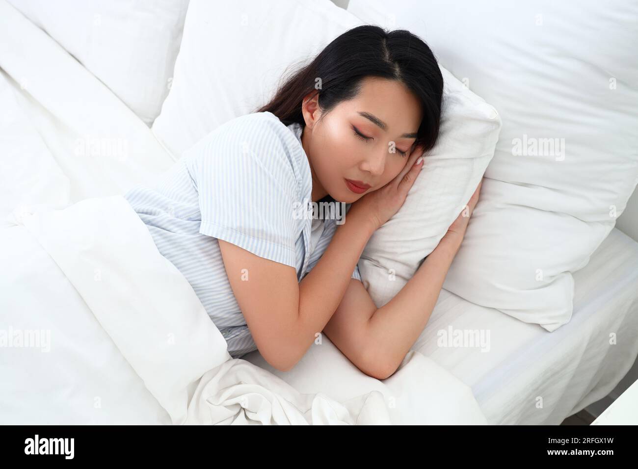Beautiful Asian woman sleeping in bed Stock Photo - Alamy