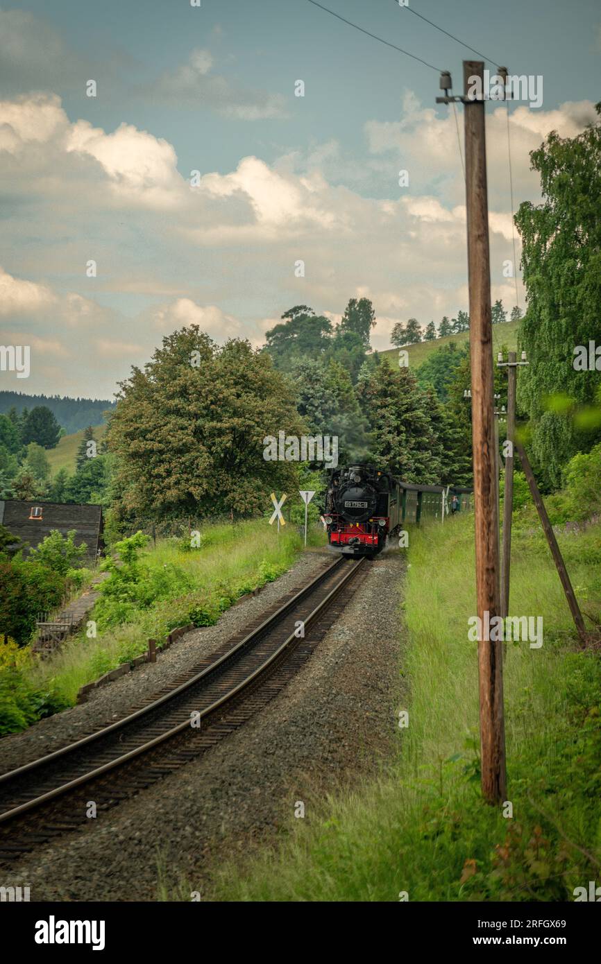Steam engine train with passengers in fresh summer day near Neudorf ...
