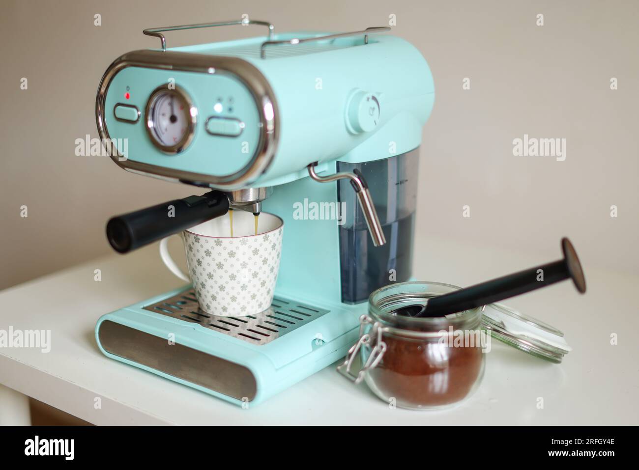 An espresso blue machine making coffee Stock Photo - Alamy