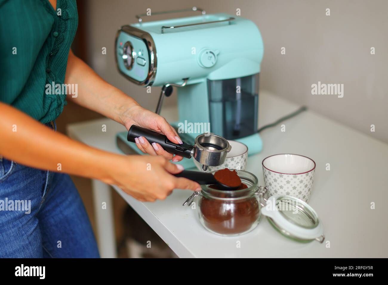 Close-up image of woman hand using blue coffee machine when making big ...