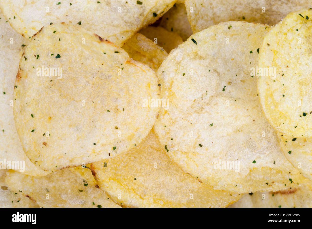 thin potato chips with spices and salt, chips fried in oil and ...