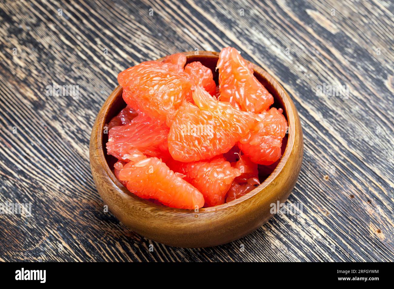 peeled pink grapefruit split into pieces while cooking, ready to eat ...