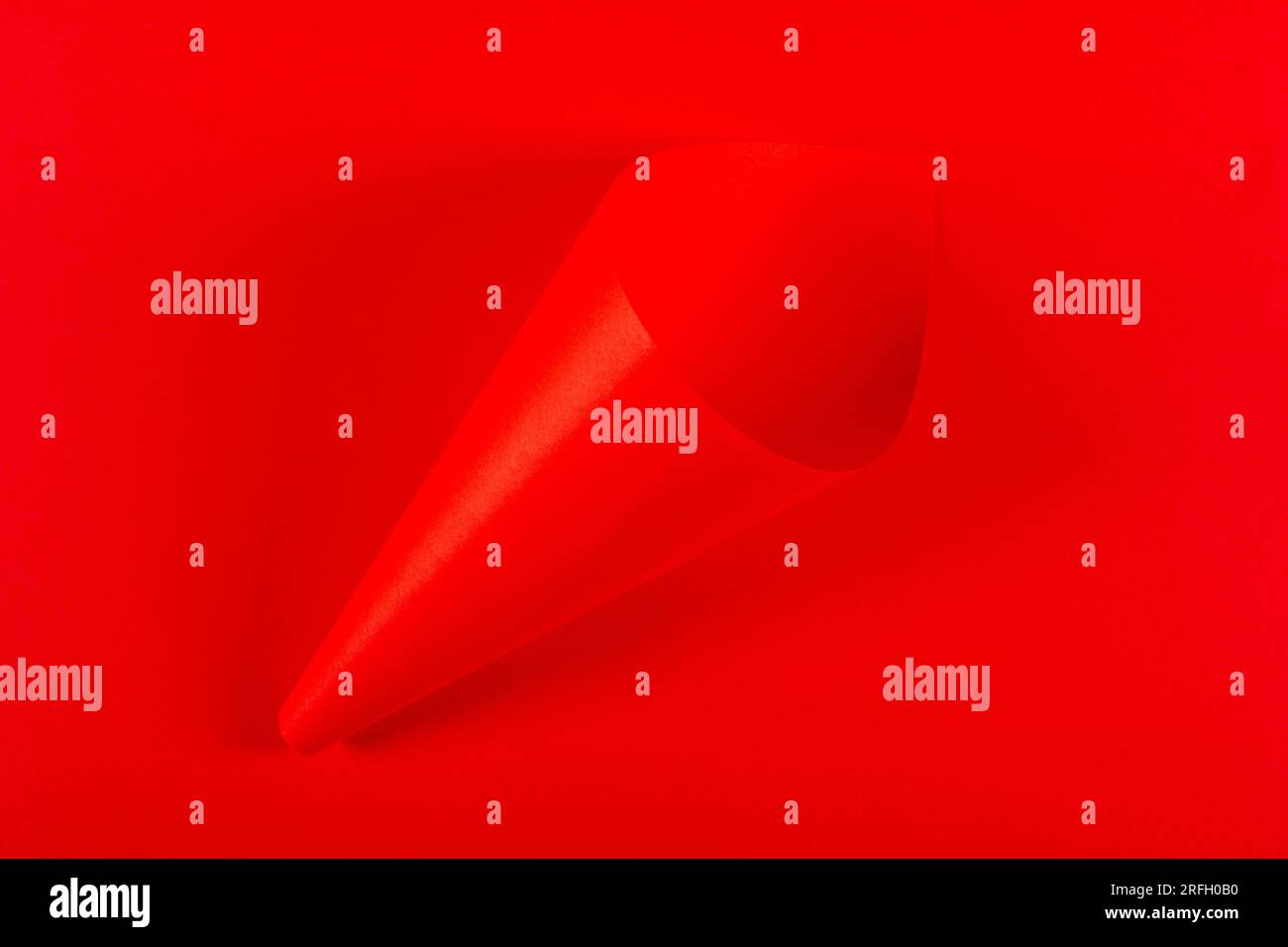Empty red paper cone lie on red background. Vibrant colors Mockup of ...
