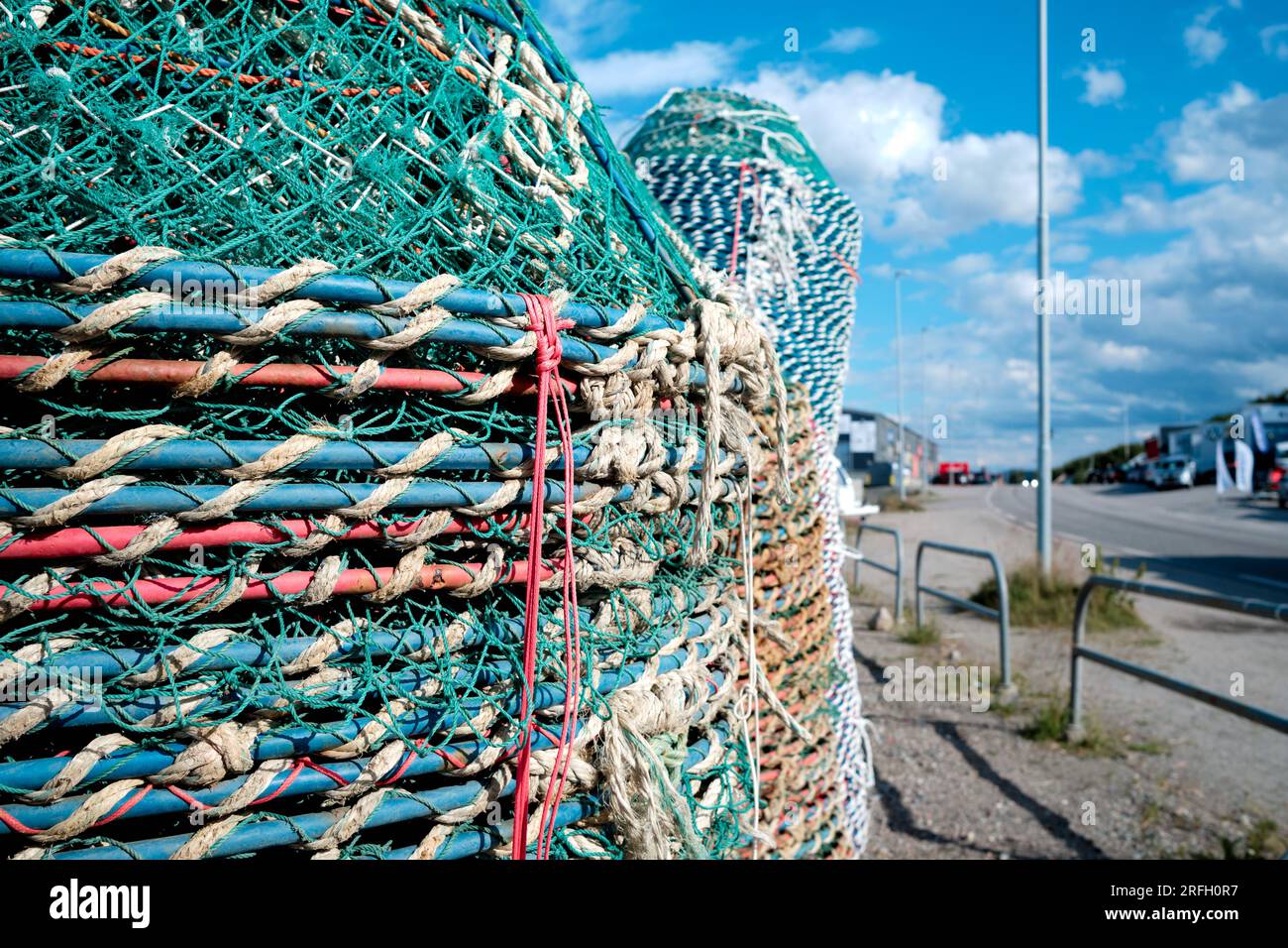 A stack of round crab traps with a green grid Stock Photo - Alamy