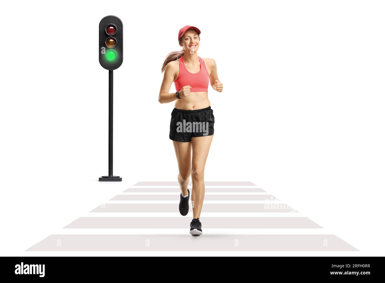 Full length portrait of a young smiling woman in sportswear jogging on ...