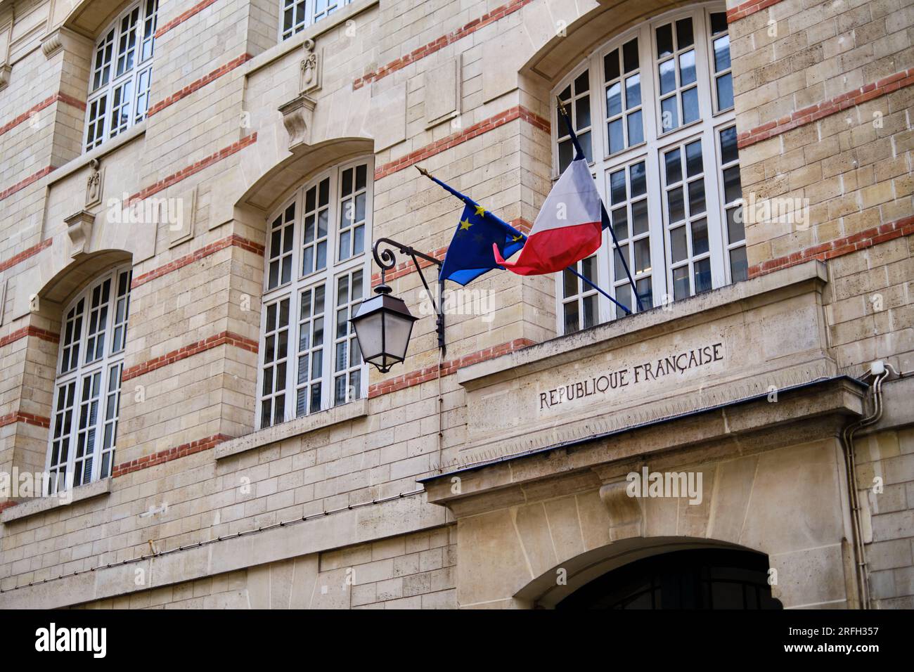 French and European Union flags fly above an administrative building in ...