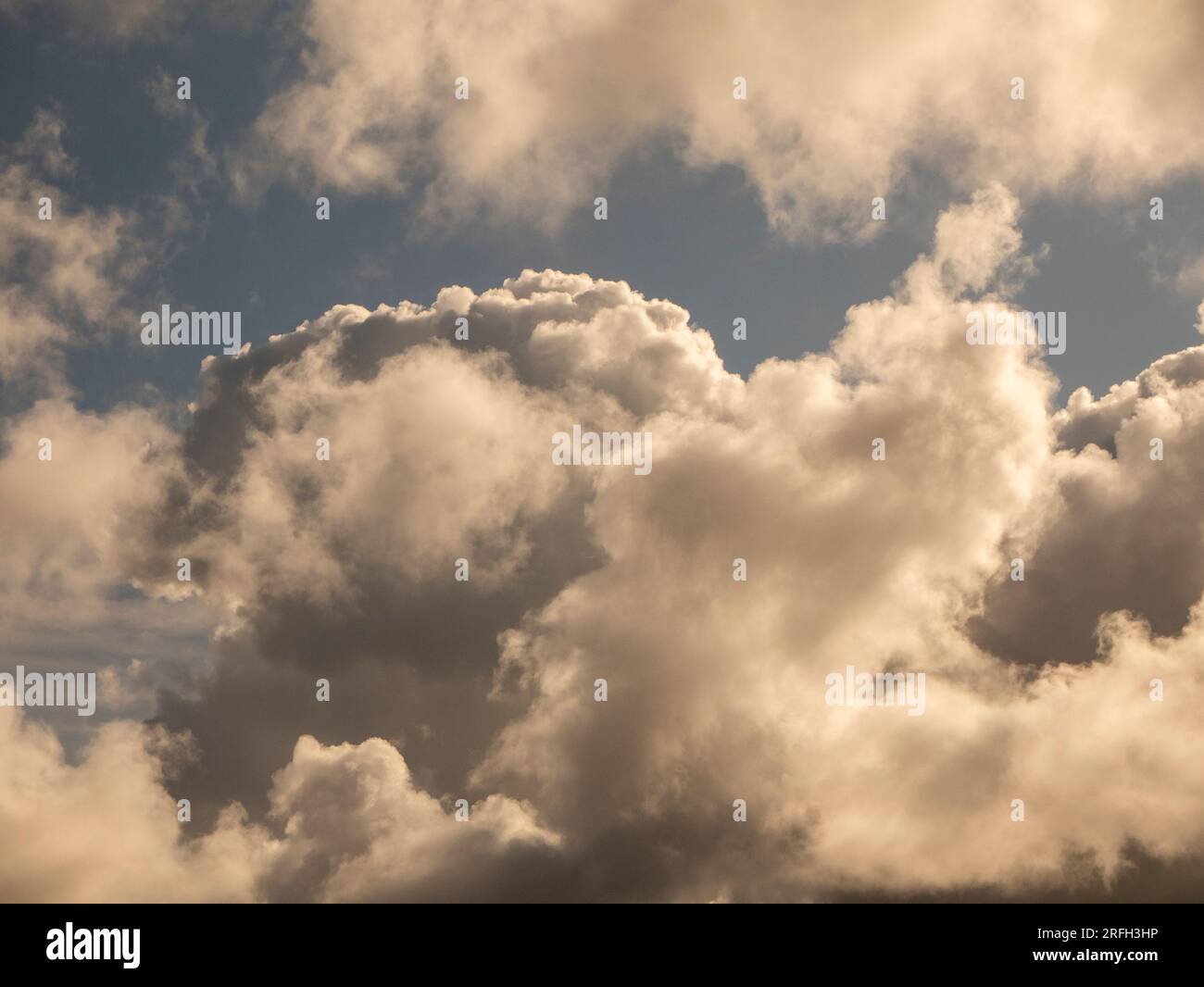 Fluffy clouds over sunset sky. Fluffy cumulus cloud shape photo, gloomy ...