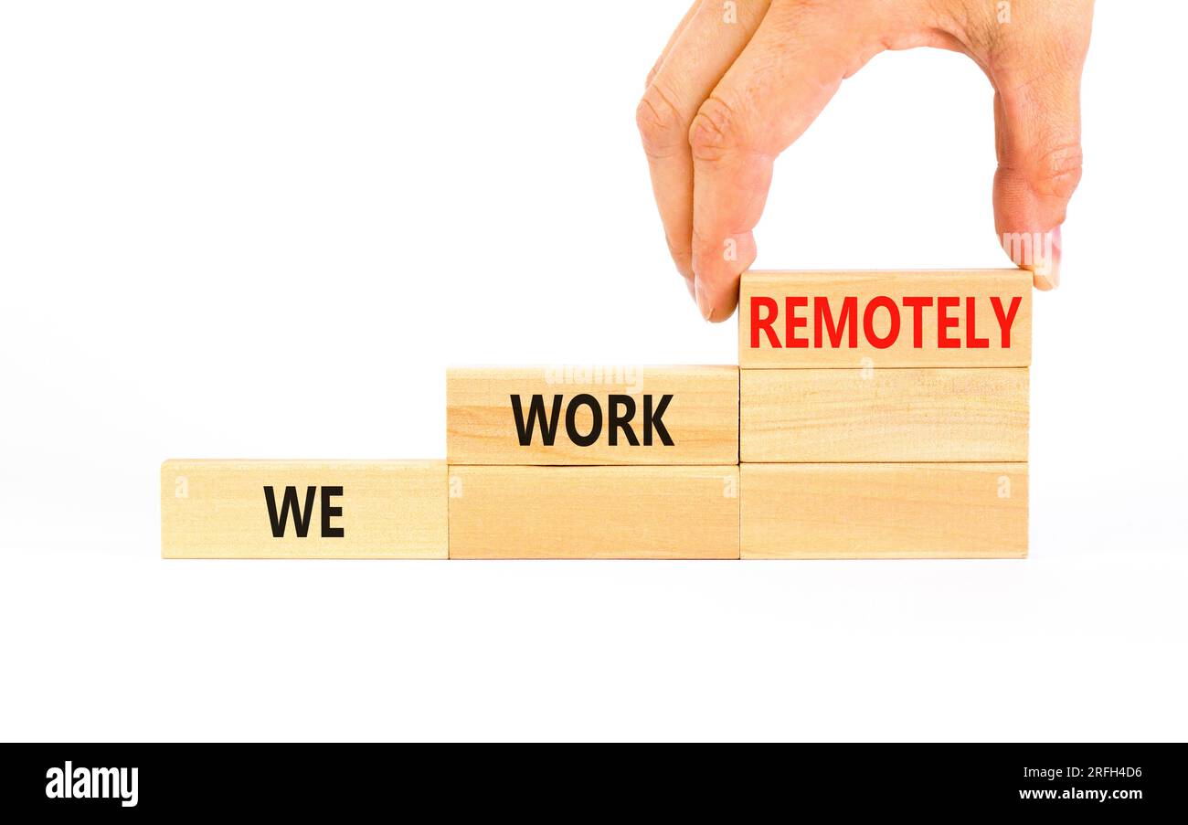 We work remotely symbol. Concept words We work remotely on wooden block ...