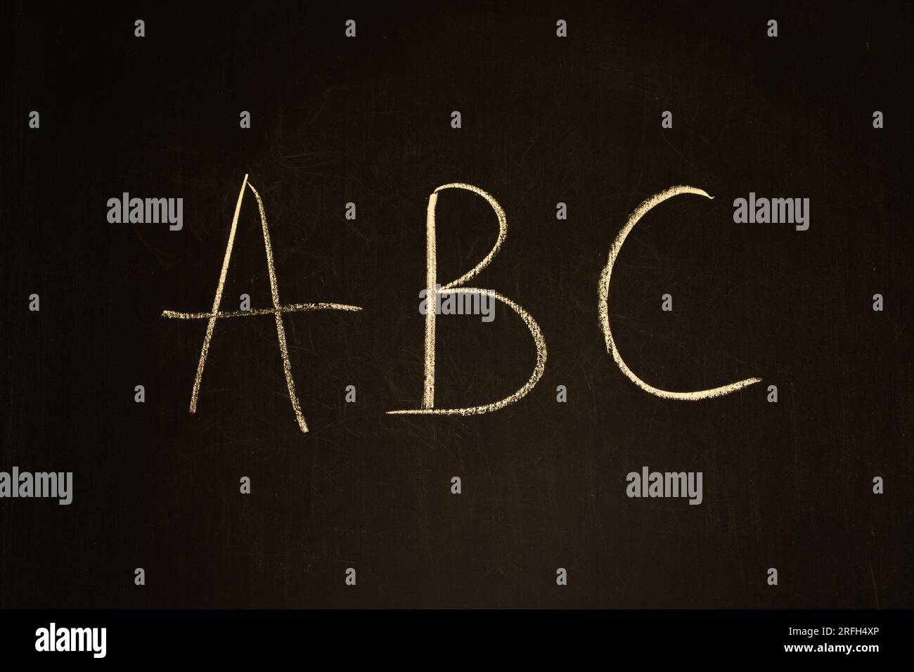 Chalk drawing on a blackboard. Letters ABC on wooden board. School ...