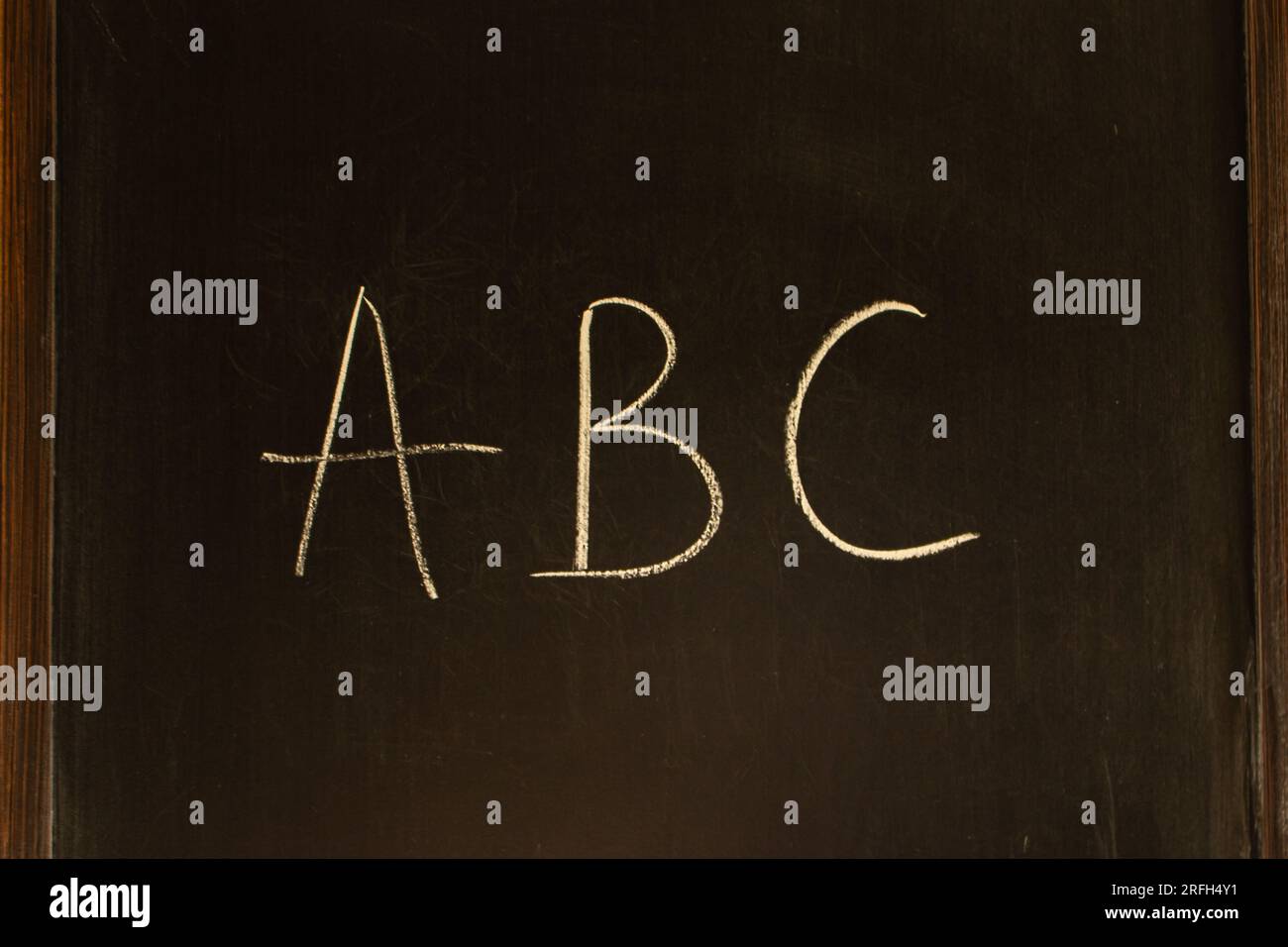 Chalk drawing on a blackboard. Letters ABC on wooden board. School chalkboard. Alphabet concept ...