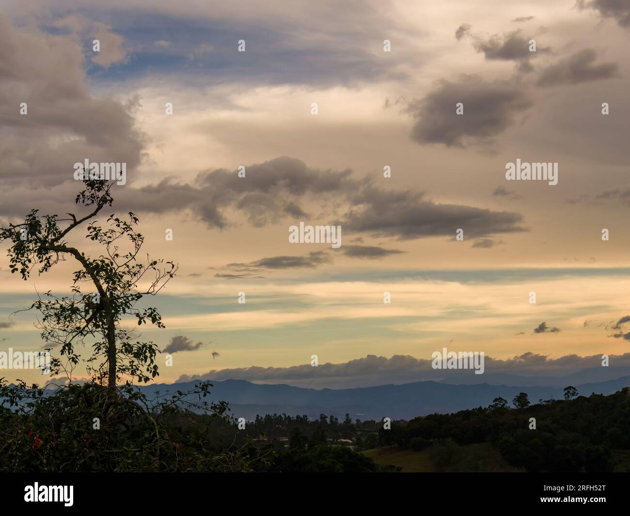 The beautiful colors of a sunset over the farmlands and mountains of ...