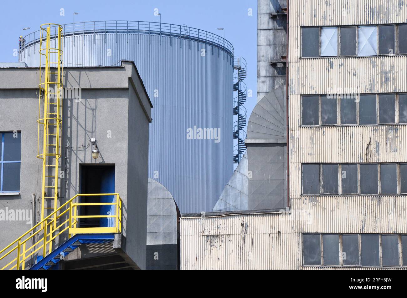 Thermal power plant, old and rusty, yellow staircase and platform, steel constructions ...