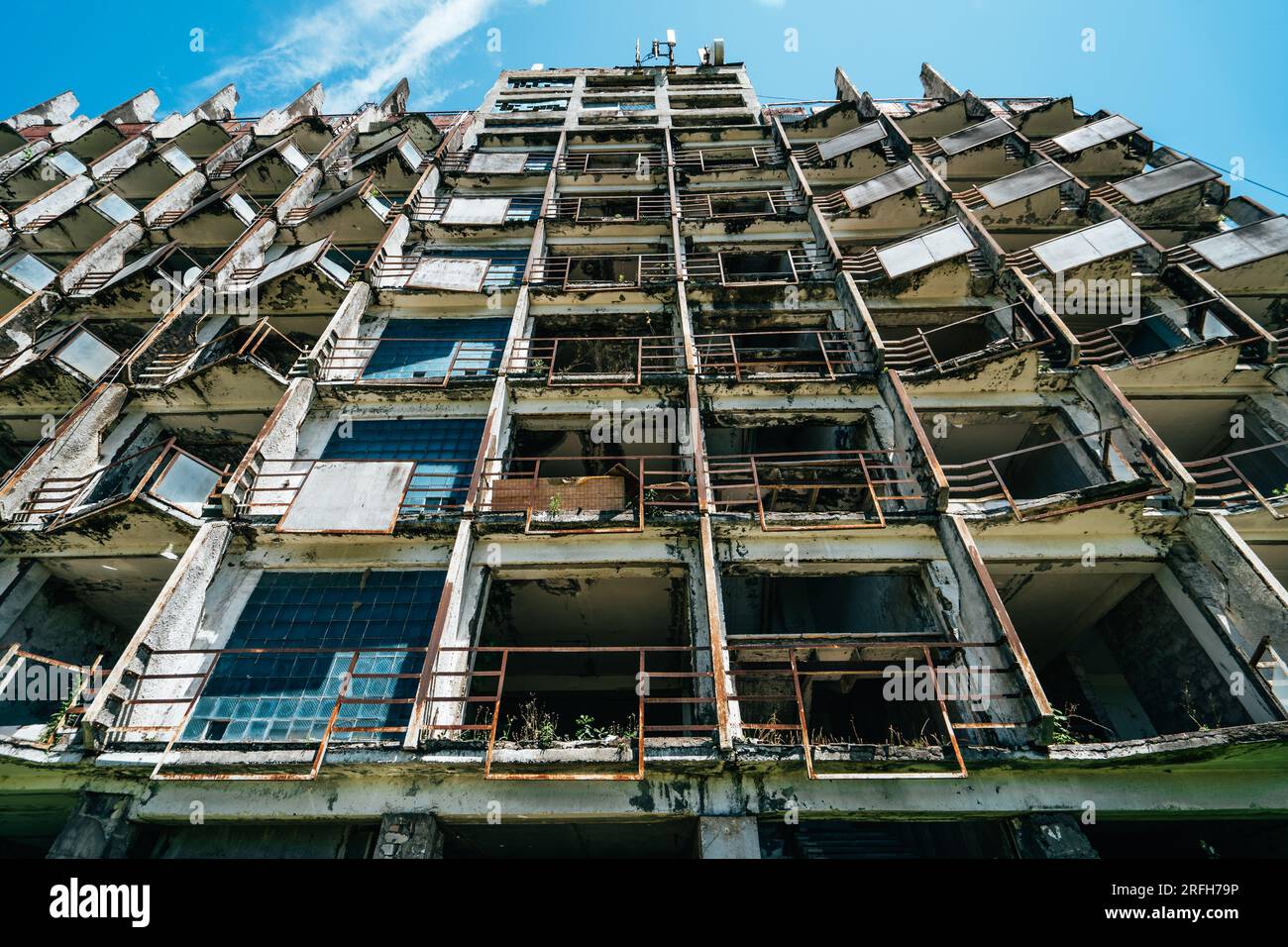 Large abandoned building overgrown with grass and plants. Urbex Lost ...