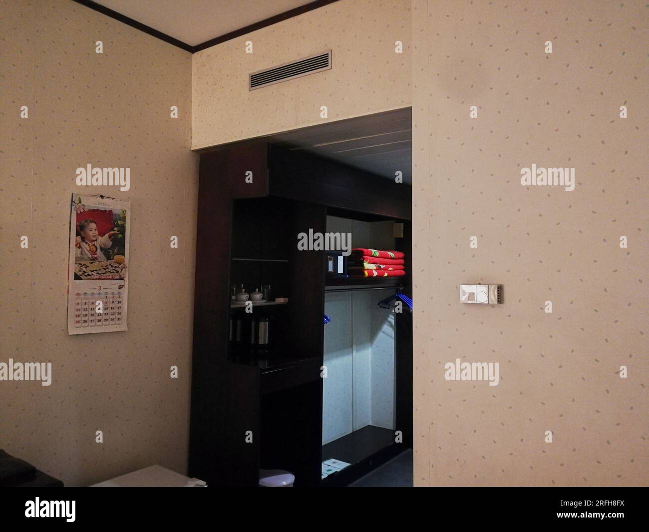 A hotel room with a bed, a desk, and a chair in the Yanggakdo ...