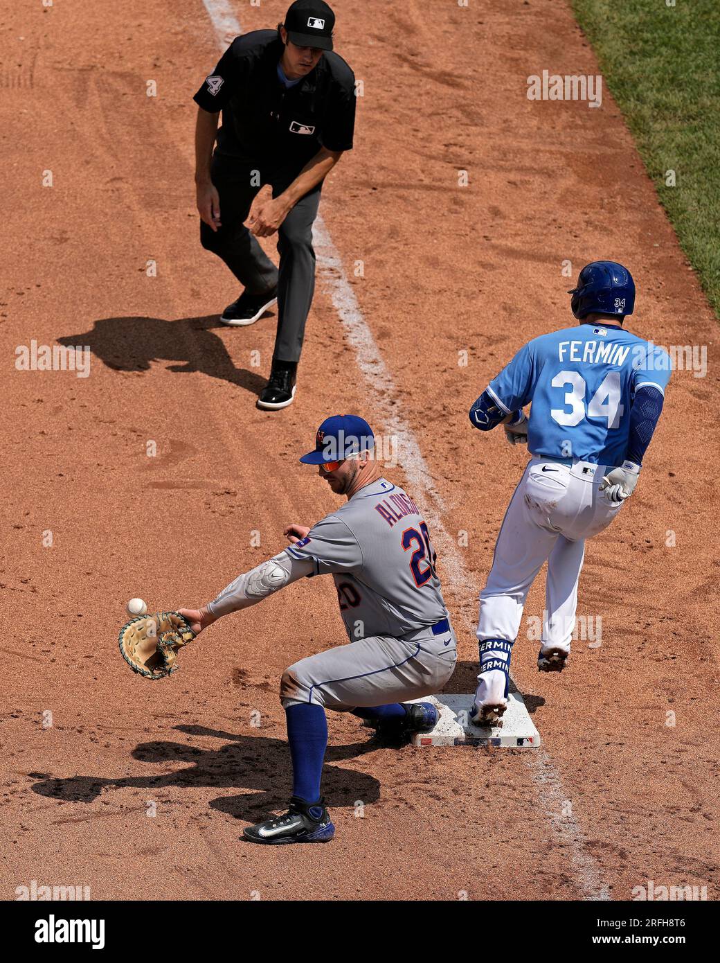 Kansas City Royals' Freddy Fermin (34) beats the tag at first by New York Mets' Pete Alonso (20 ...