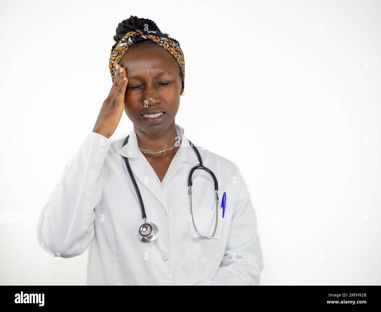 Young female doctor having a headache. Isolated on white background ...