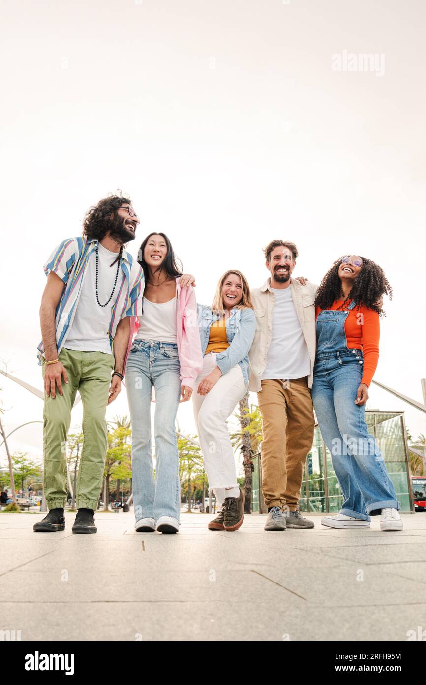 Vertical portrait of happy young adult friends having fun, laughing ...
