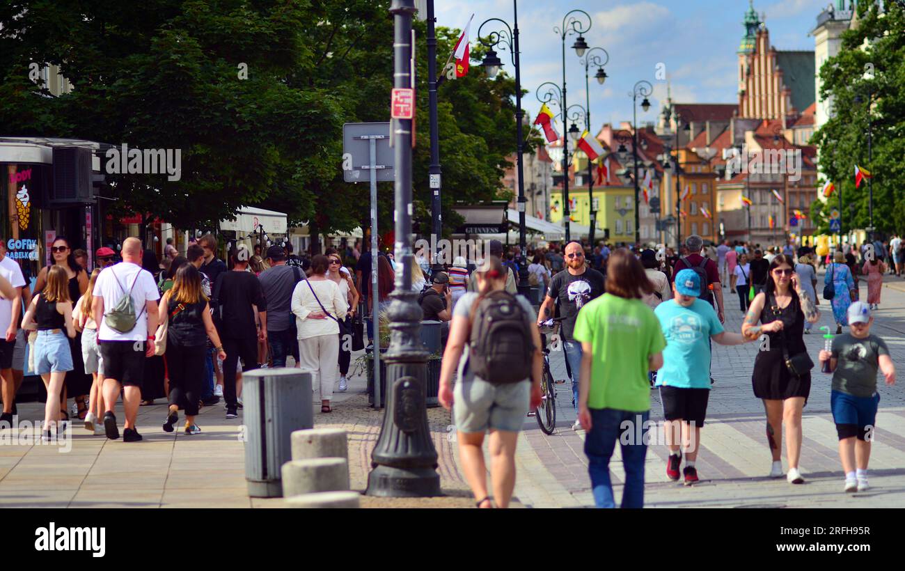 Warsaw, Poland. 29 July 2023. Crowd of people walking on a street. A ...