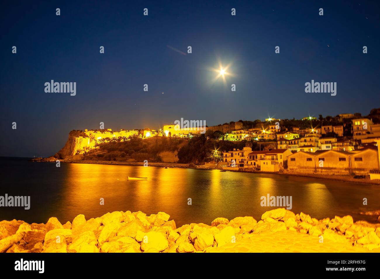 The illuminated castle of Koroni by night against a full moon in Koroni ...
