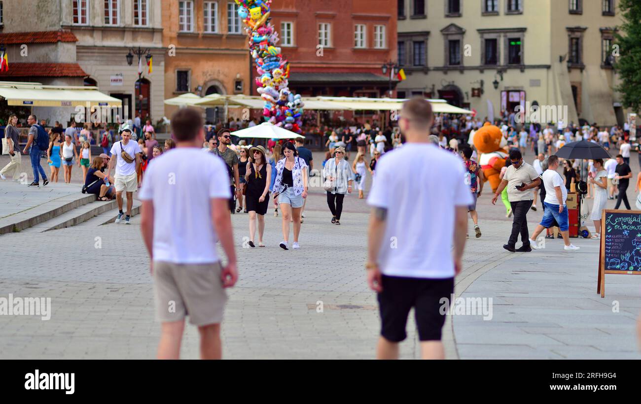 Warsaw, Poland. 29 July 2023. Crowd of people walking on a street. A ...