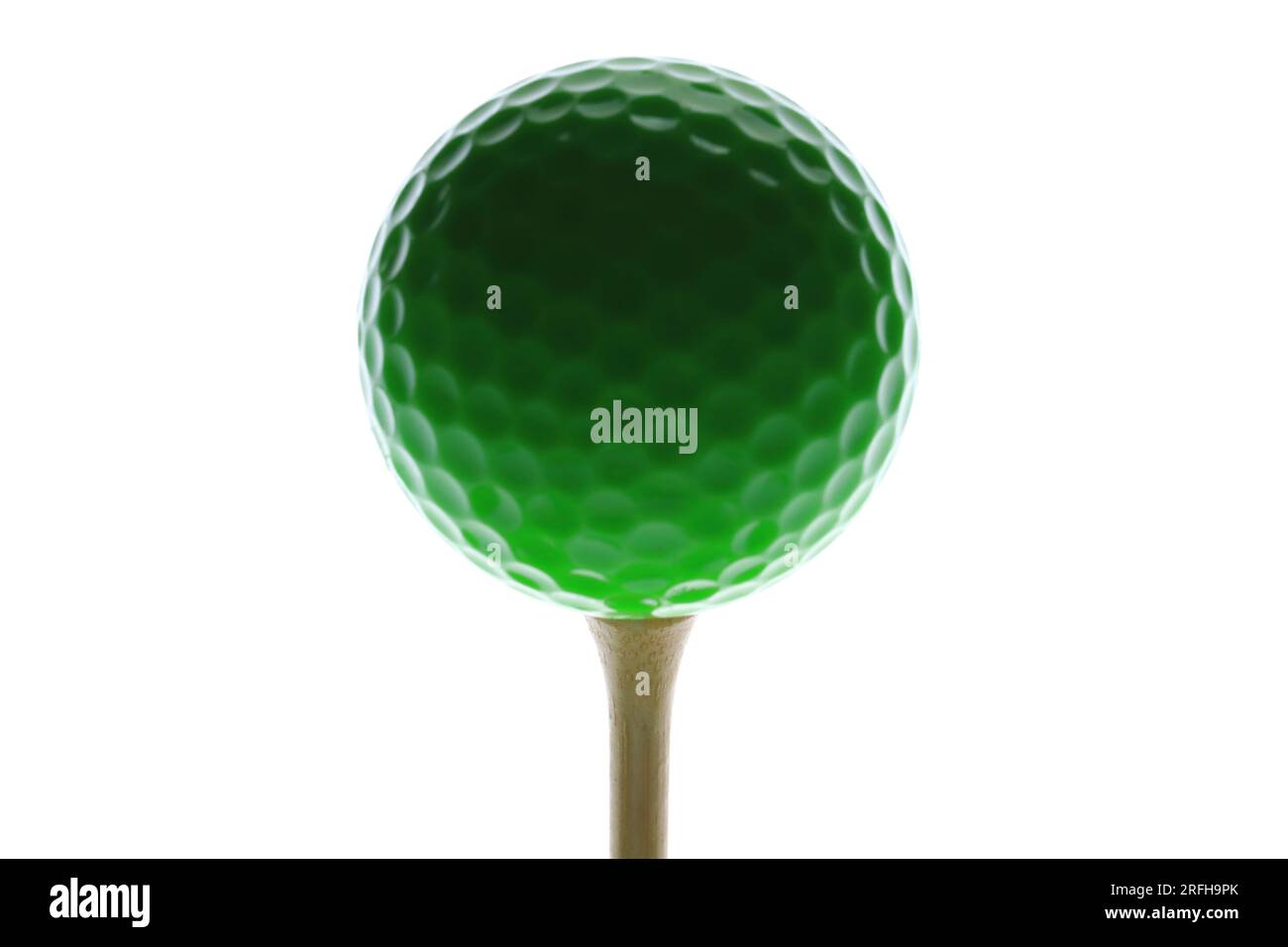 Golf ball balancing on tee Stock Photo - Alamy
