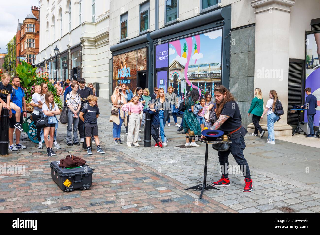 Australian street magician Jason Maher performs and entertains a crowd ...