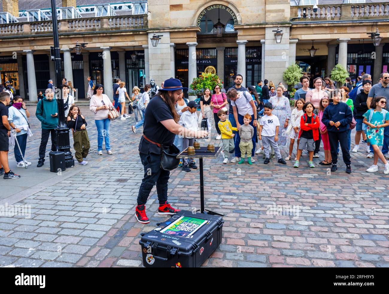 Australian street magician Jason Maher performs and entertains a crowd ...