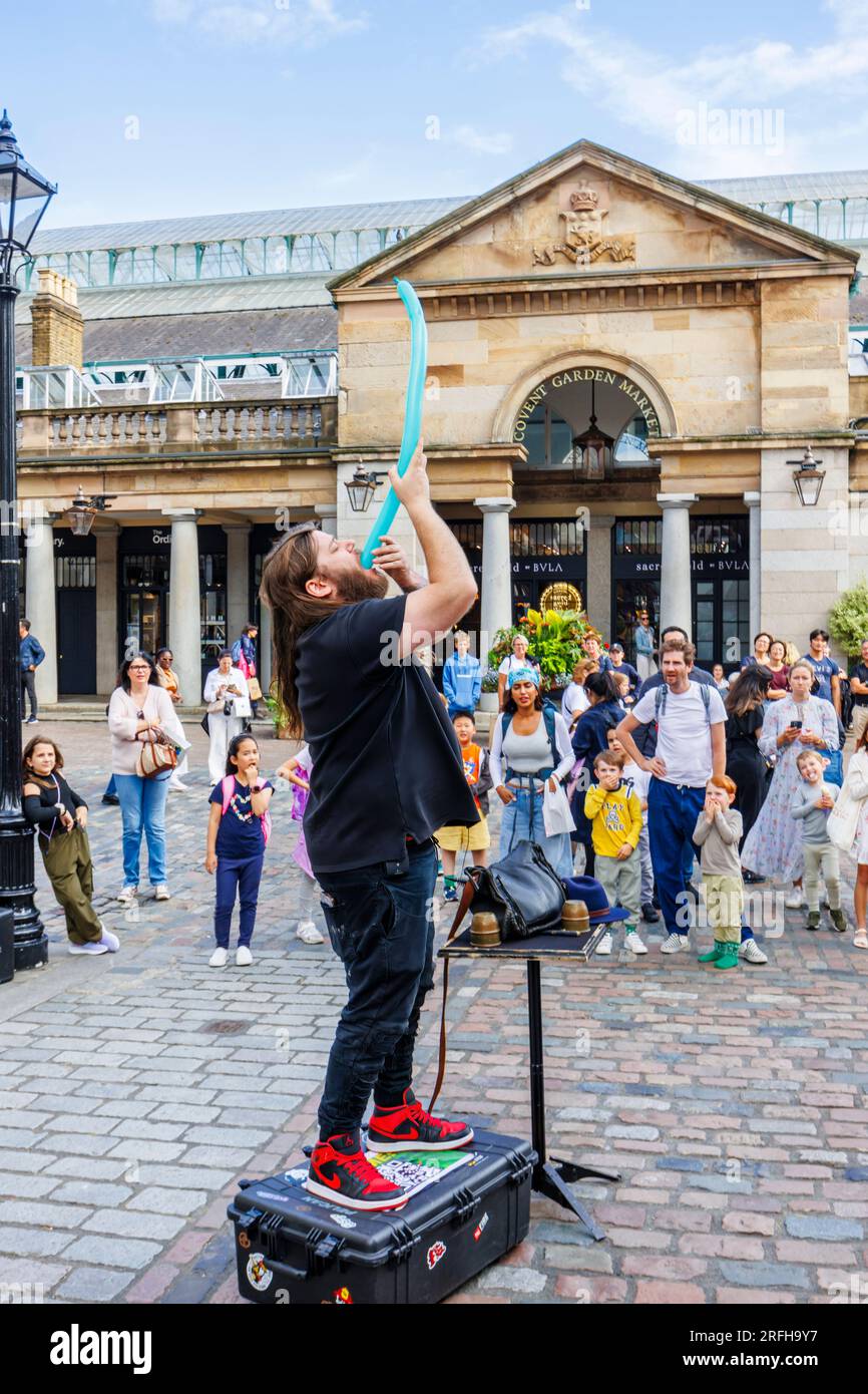 Australian street magician Jason Maher swallowing a balloon performs ...