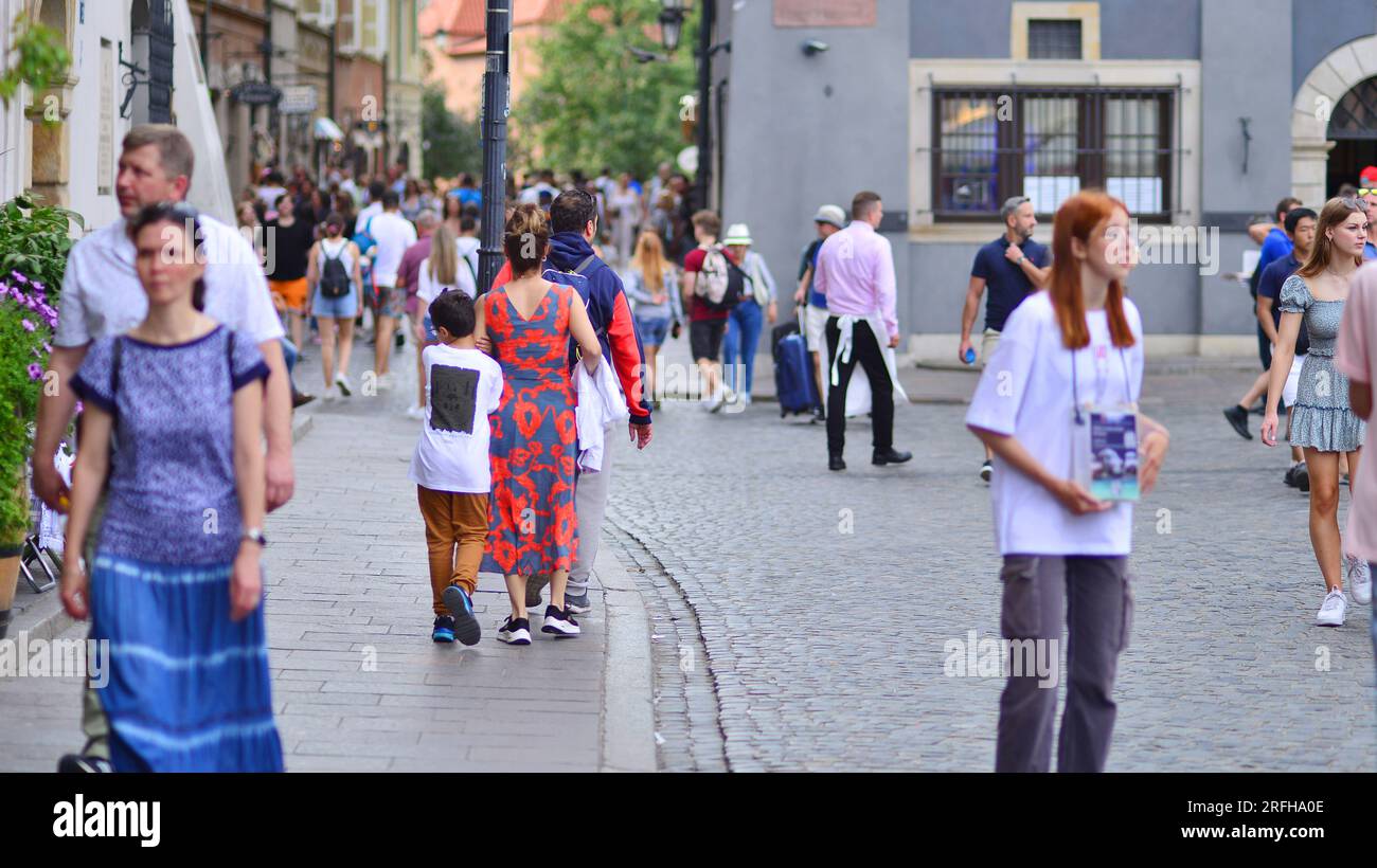 Warsaw, Poland. 29 July 2023. Crowd of people walking on a street. A ...