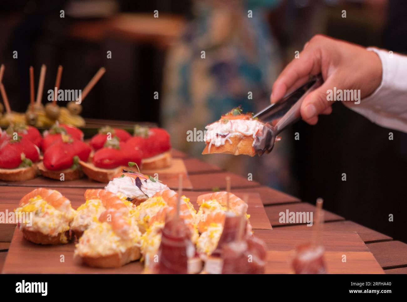 hand holding a traditional basque appetizer Stock Photo - Alamy