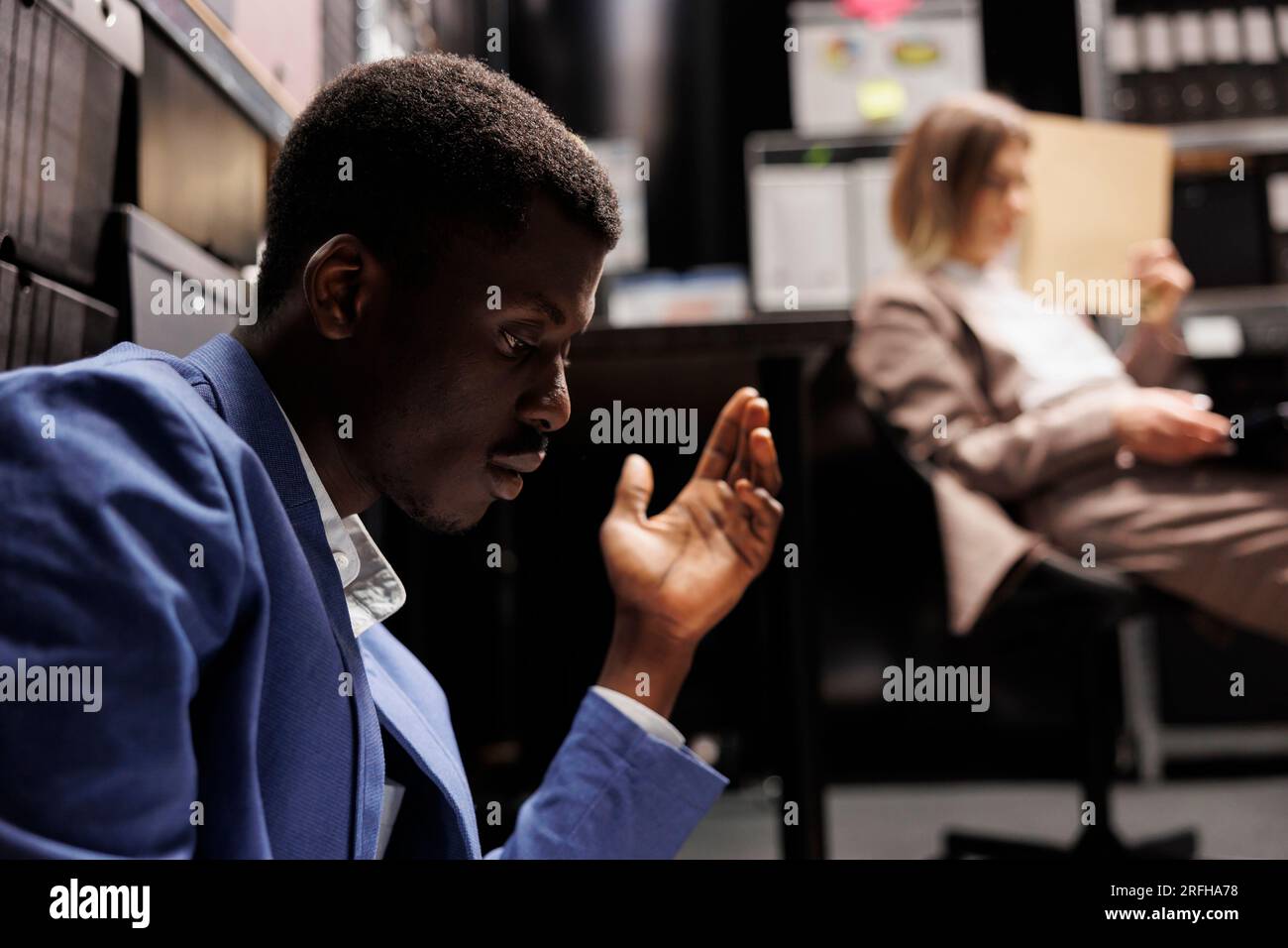 Tired Diverse Colleagues Working Overtime In Arhive Room Analyzing Criminal Case Evidence