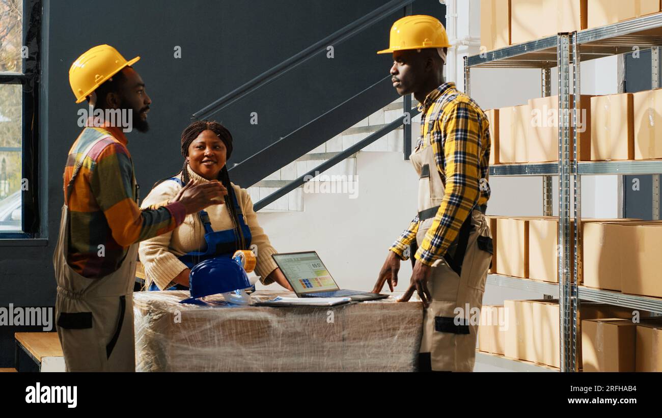 African american workers packing shipment boxes in depot, working on ...