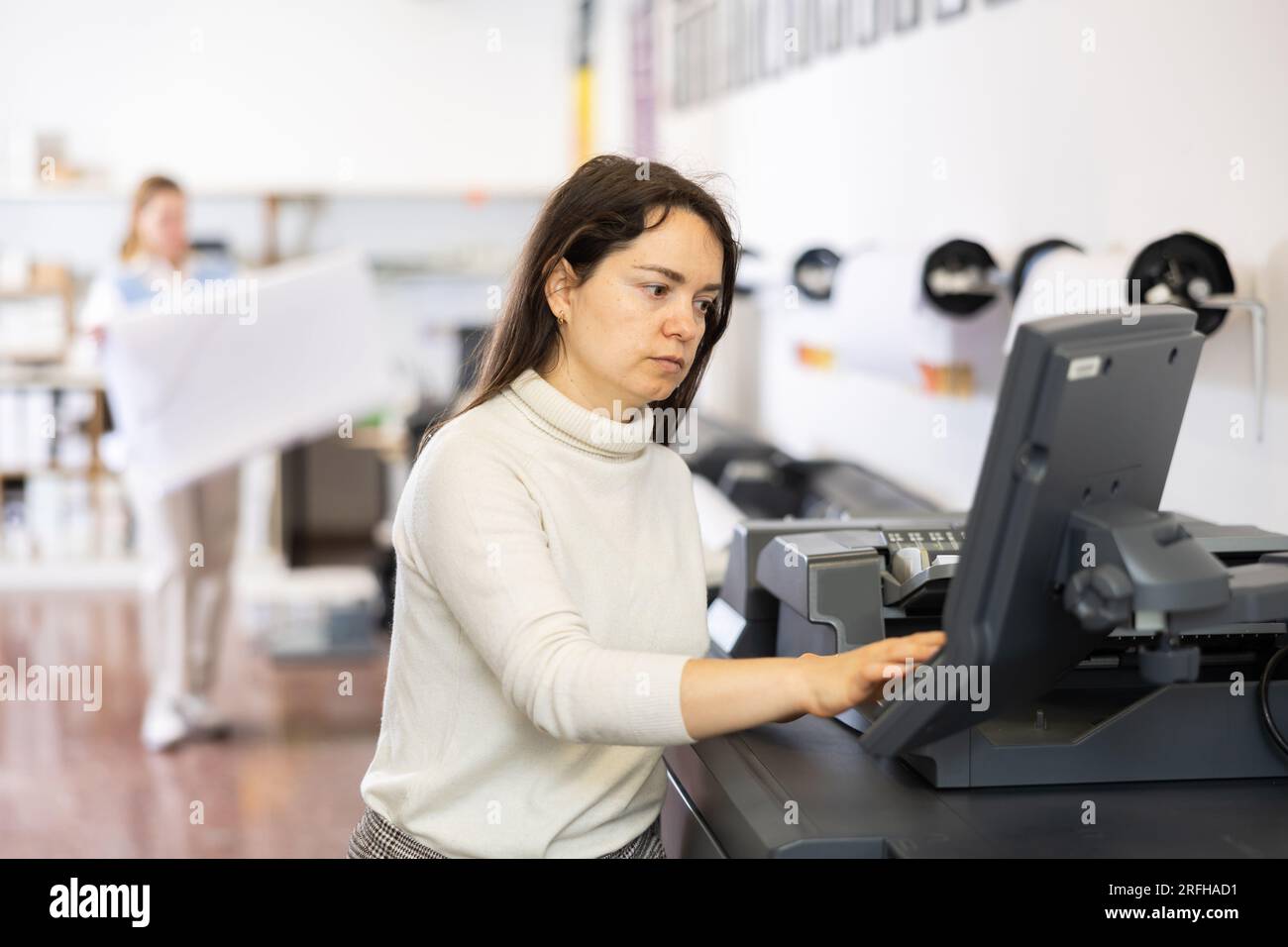 Technician operator calibrating plotter machine, typing on computer keyboard Stock Photo - Alamy