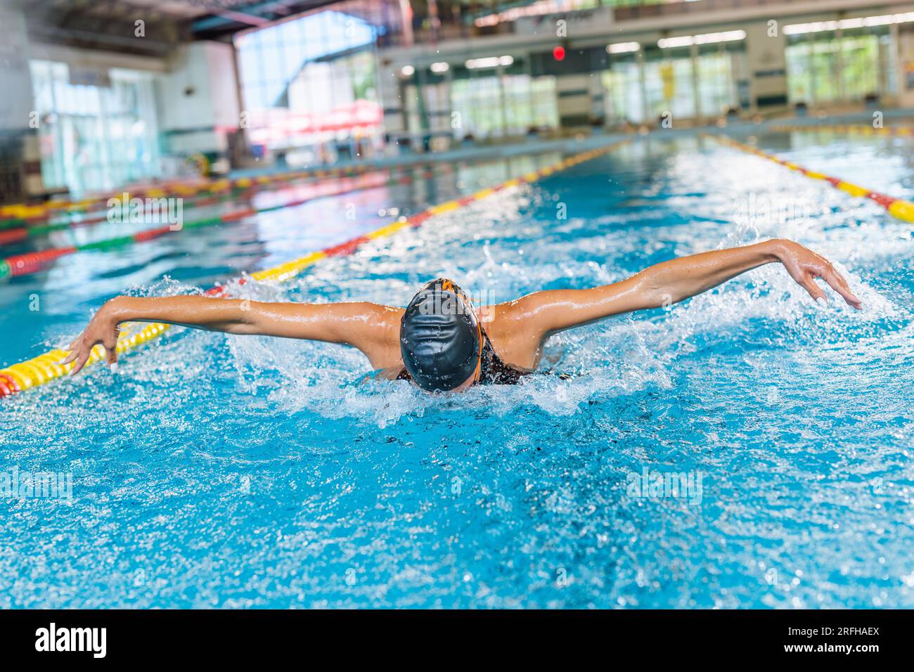 Well trained professional female swimmer in the butterfly stroke, arms ...