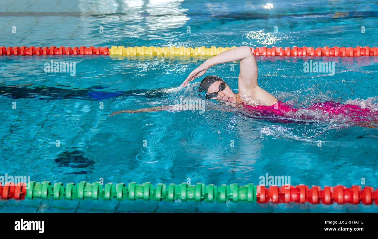 Elite female athlete, professional swimmer during a front crawl ...