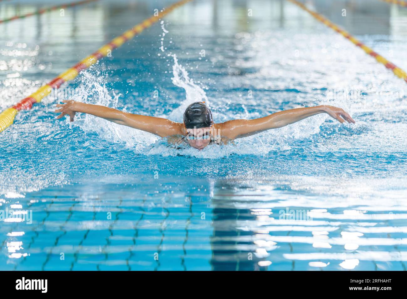 Front view of a powerful elite female swimmer competitor performing ...