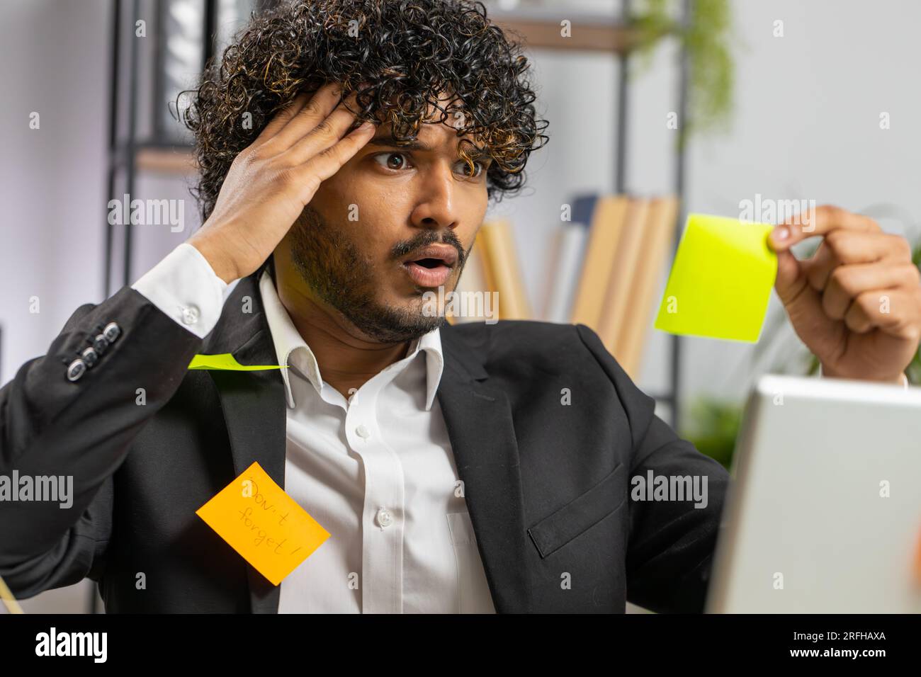 Tired exhausted indian businessman working on laptop at office with ...