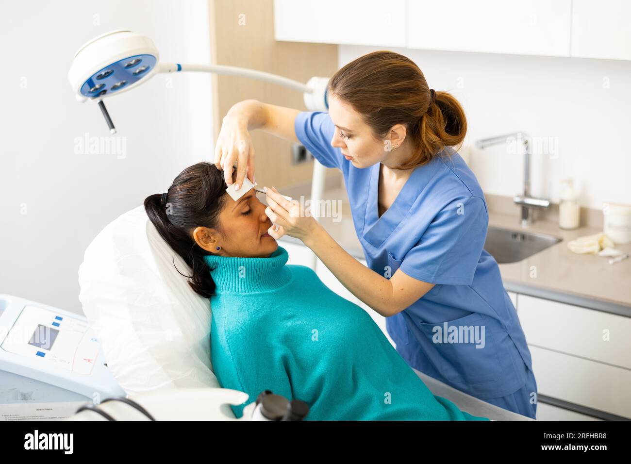Beautician drawing correction lines on woman face Stock Photo - Alamy