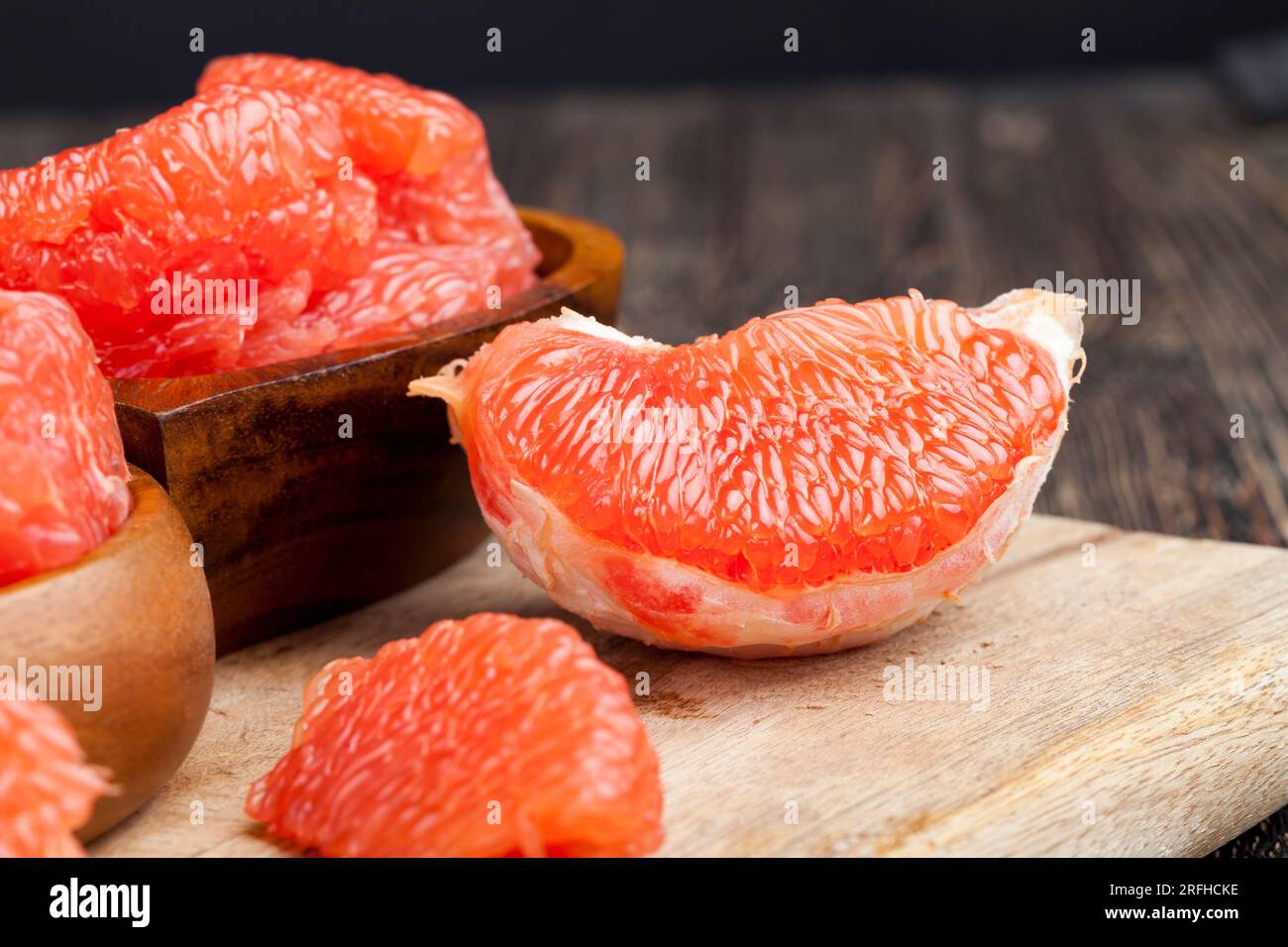 peeled pink grapefruit split into pieces while cooking, ready to eat ...