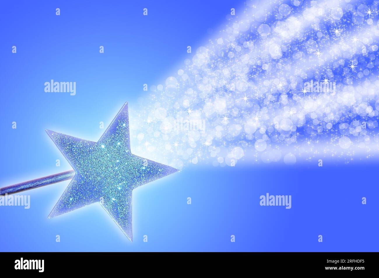 A radiant magic wand projecting white rays of sparkling particles ...